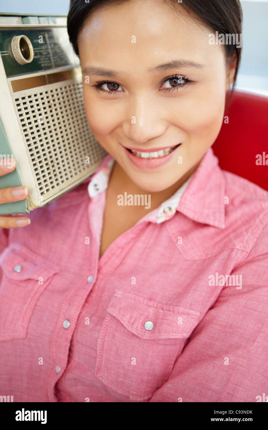 Young woman listening to radio Stock Photo - Alamy