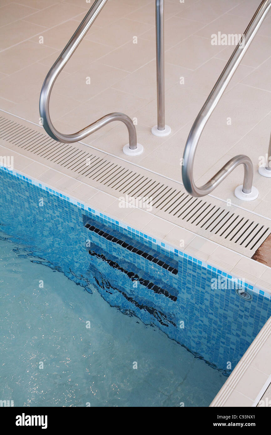 Swimming pool steps and hand rails Stock Photo - Alamy