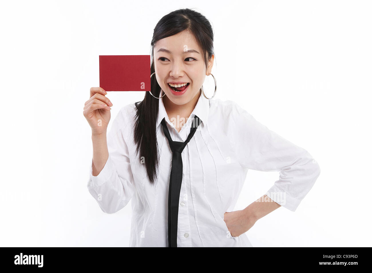 Teenage girl holding card sign in hand, smiling, studio shot Stock ...