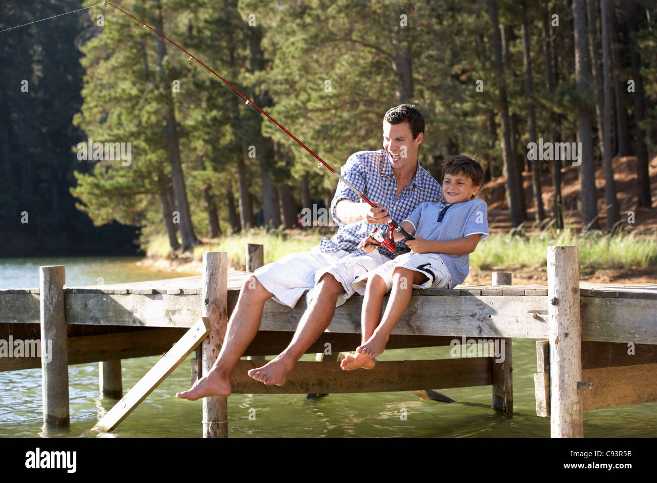 Dad helping son fish hi-res stock photography and images - Alamy