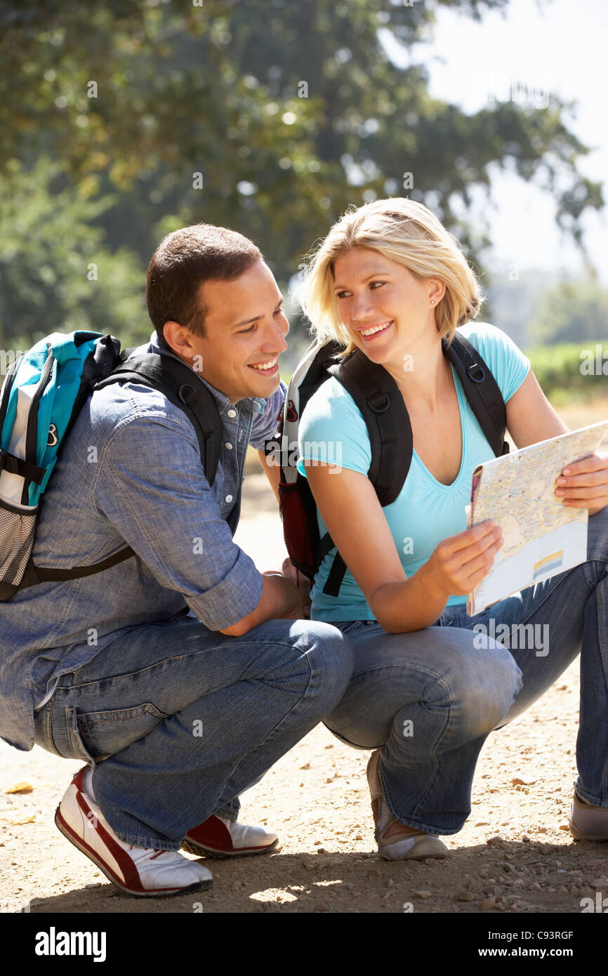 Couple with map on country walk Stock Photo - Alamy