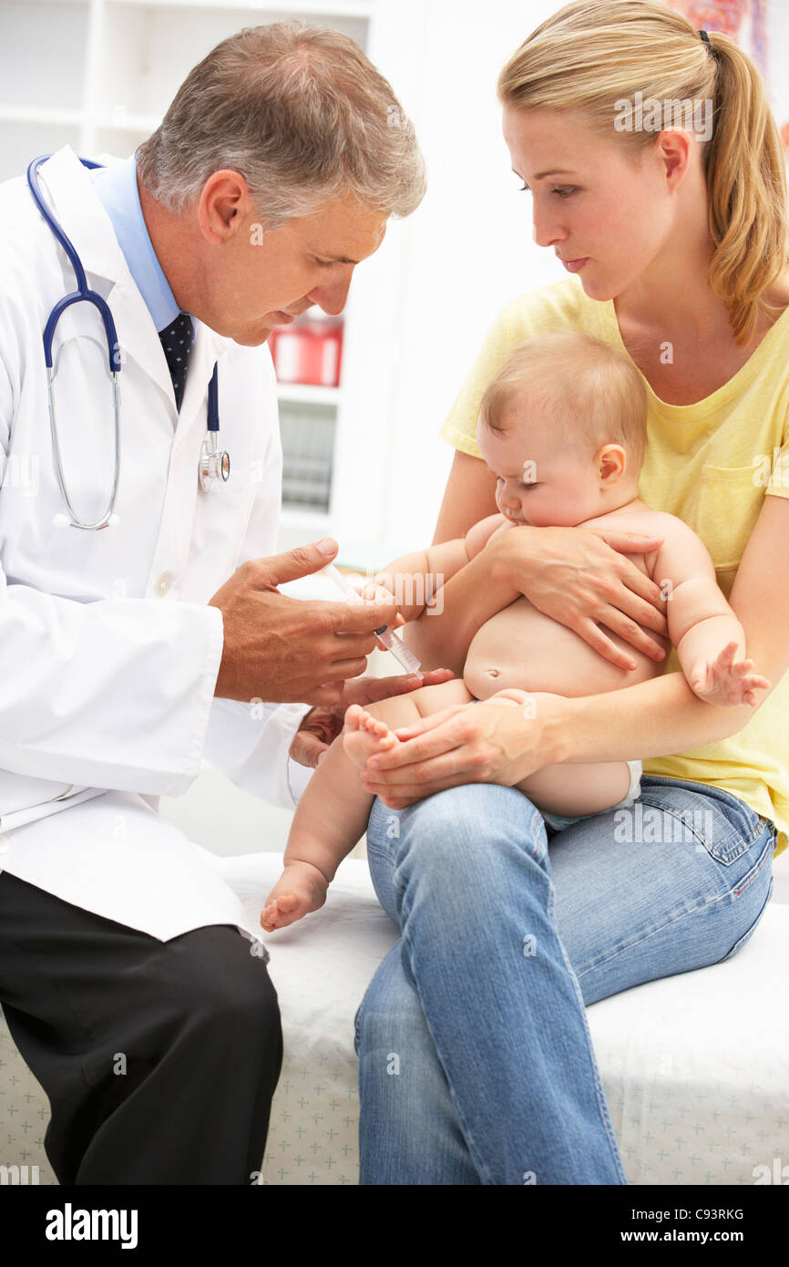 Pediatrician with baby Stock Photo - Alamy