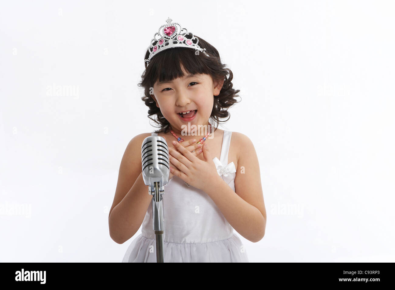 A cute girl singing song on mike, portrait Stock Photo - Alamy