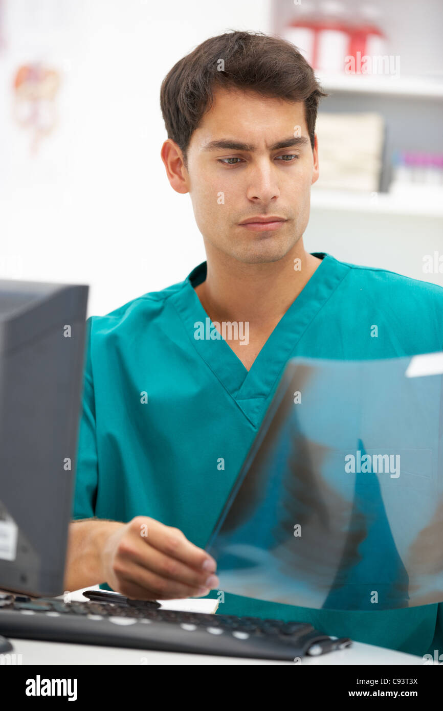 Young hospital doctor at desk Stock Photo - Alamy