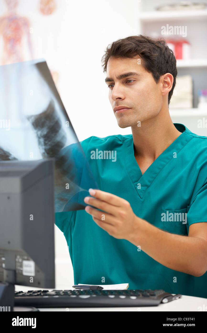 Young hospital doctor at desk Stock Photo - Alamy
