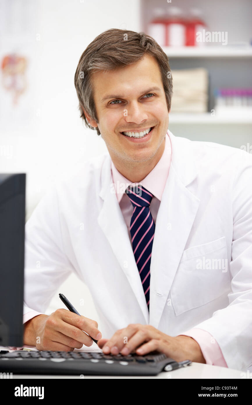 Hospital doctor at desk Stock Photo - Alamy