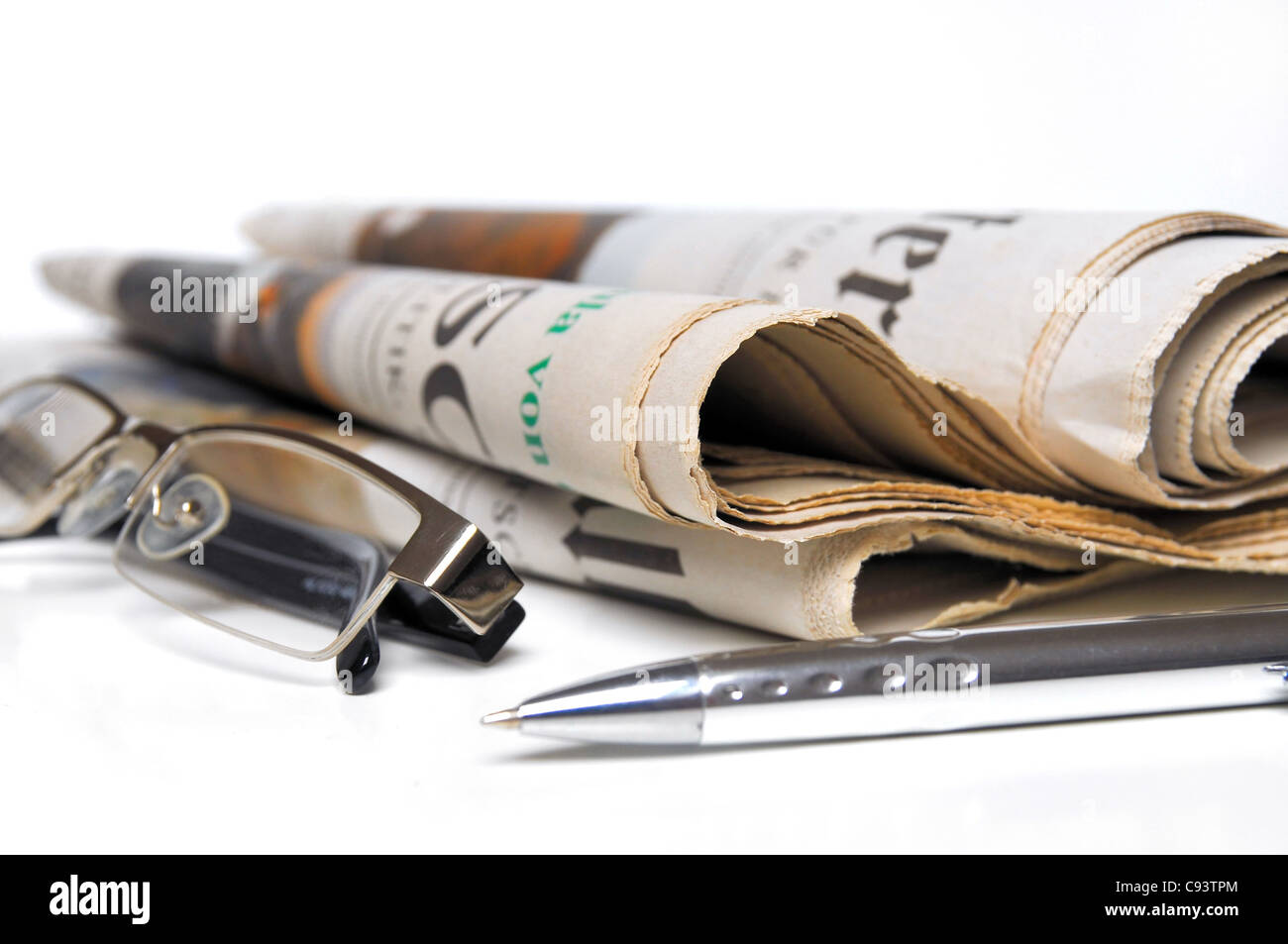 Still life - Newspaper, glasses and ball pen over white background ...