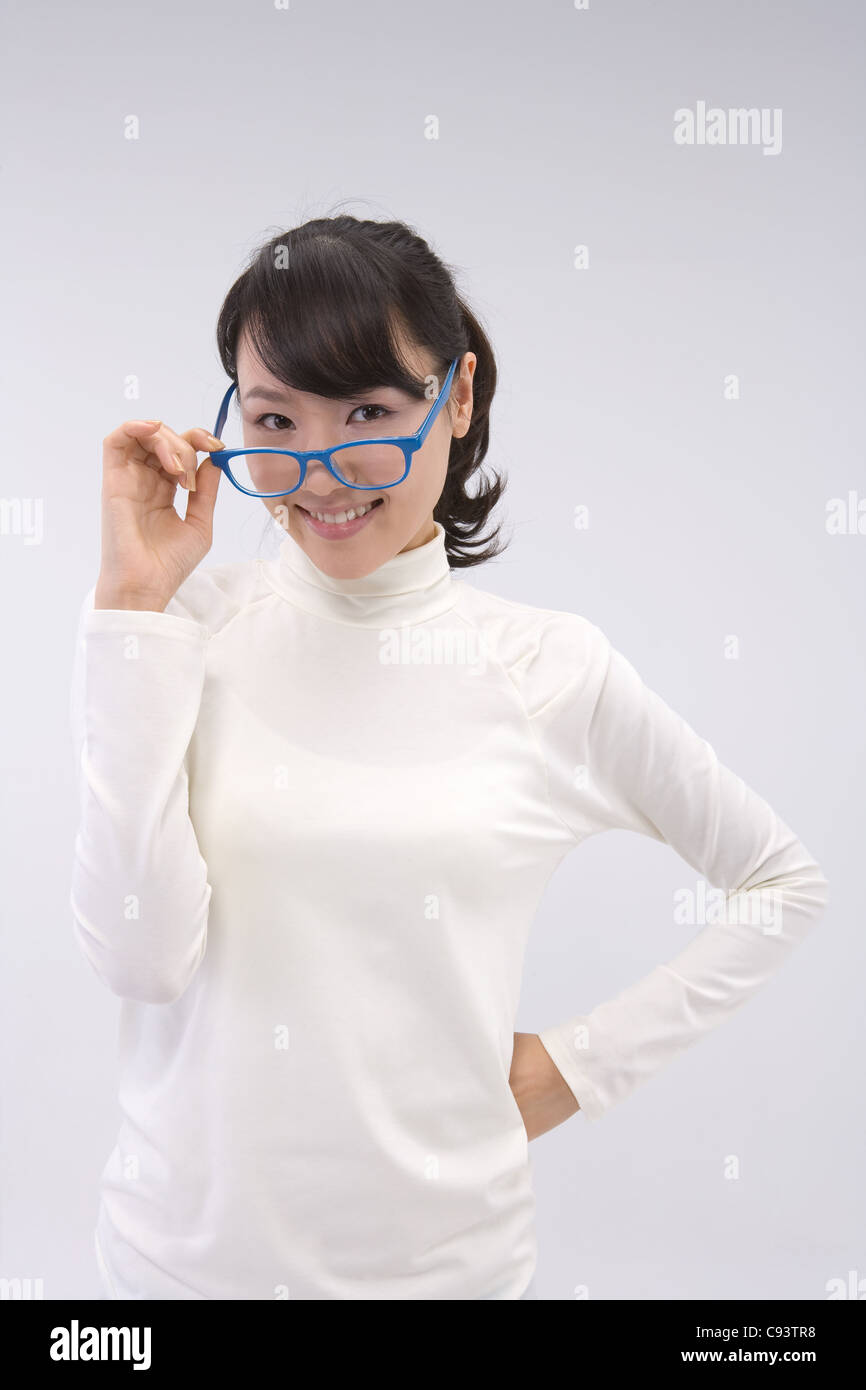Portrait of young woman wearing specs Stock Photo - Alamy