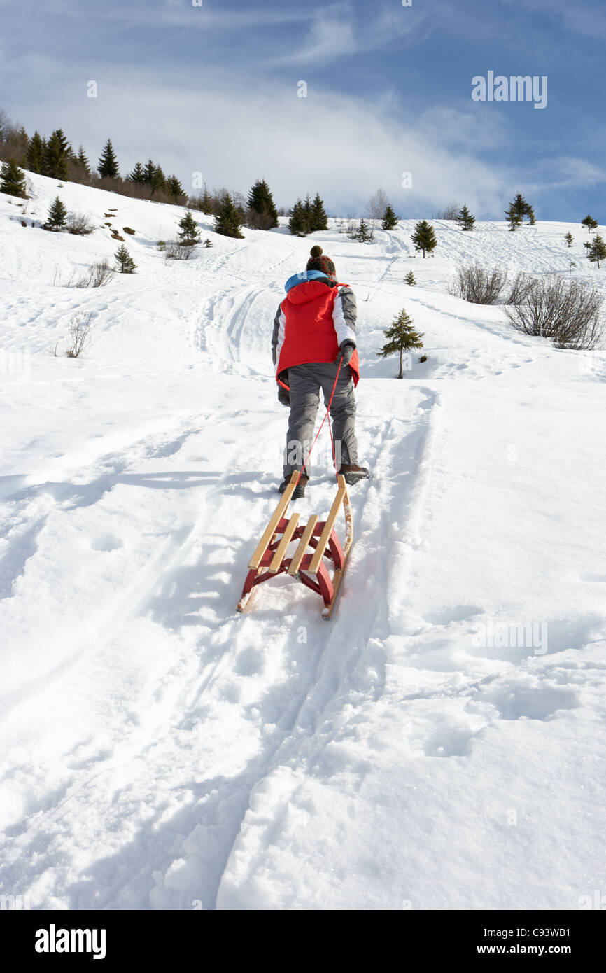 Pre-teen Boy Pulling A Sled In The Snow Stock Photo - Alamy