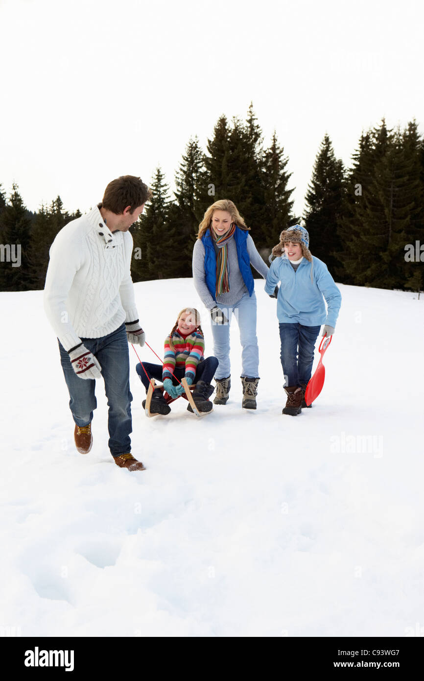 Young Family In , Snow Scene With Sled Stock Photo - Alamy