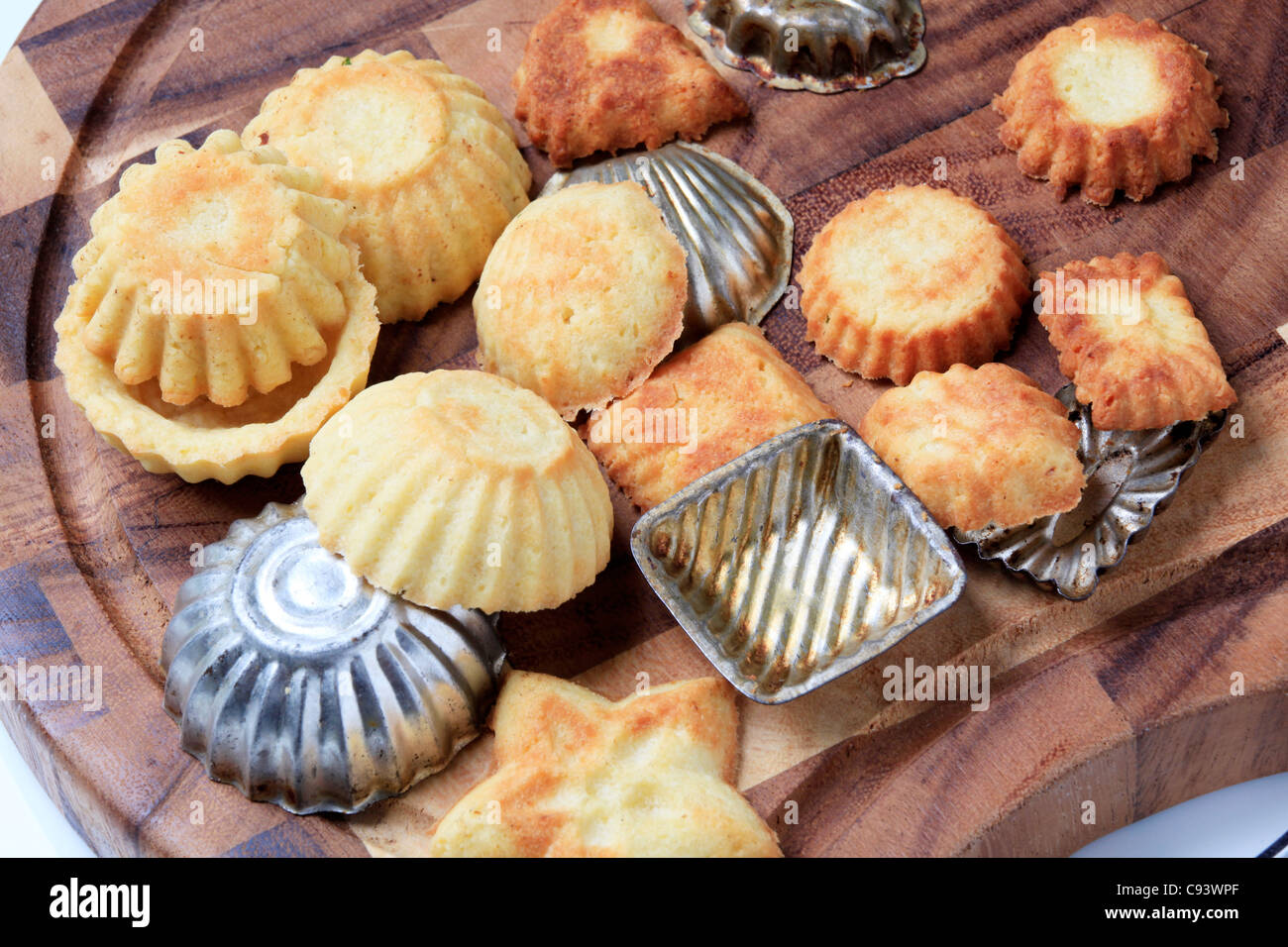 Small tart shells and baking pans on a cutting board Stock Photo - Alamy