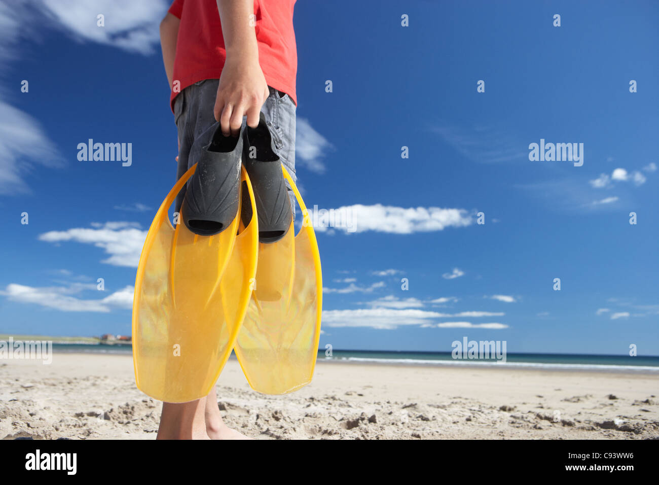 Teenage boy on beach with flippers Stock Photo - Alamy