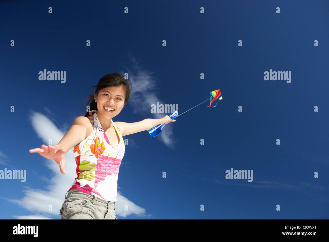 Teenage girl flying a kite Stock Photo - Alamy