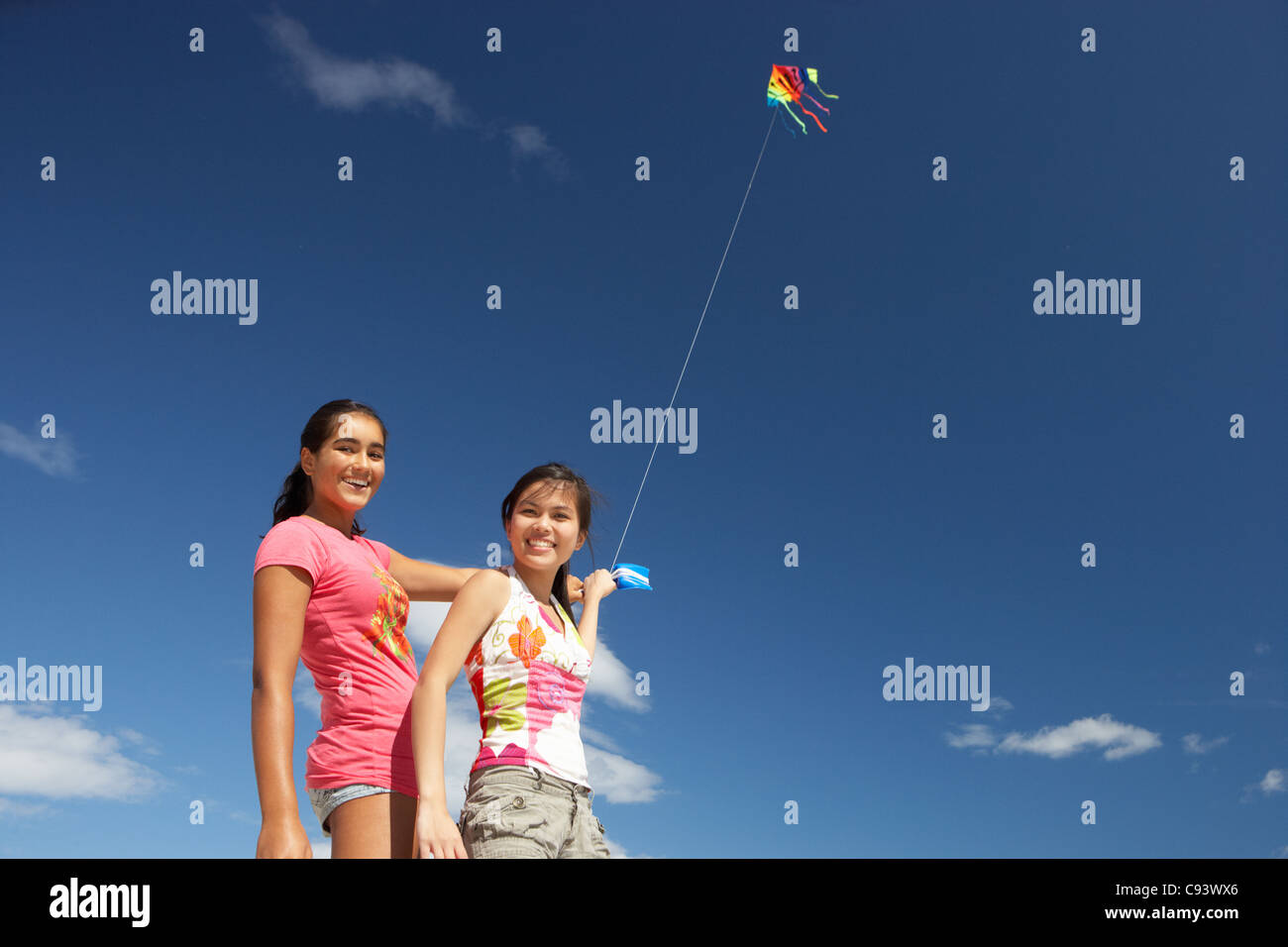 Teenage girls flying a kite Stock Photo - Alamy