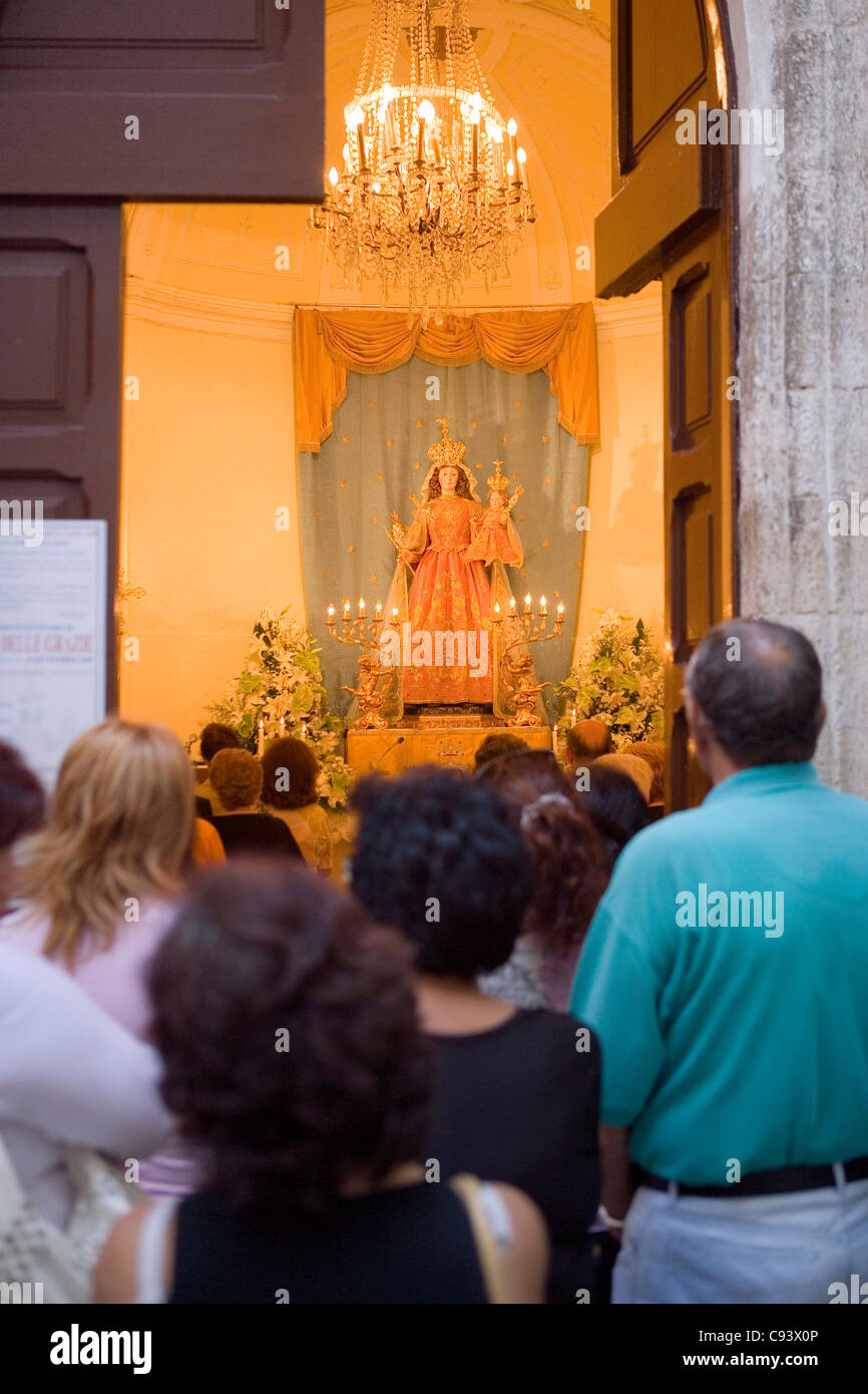 Worshippers crowd a church for Sunday mass in Bari's back streets Stock ...