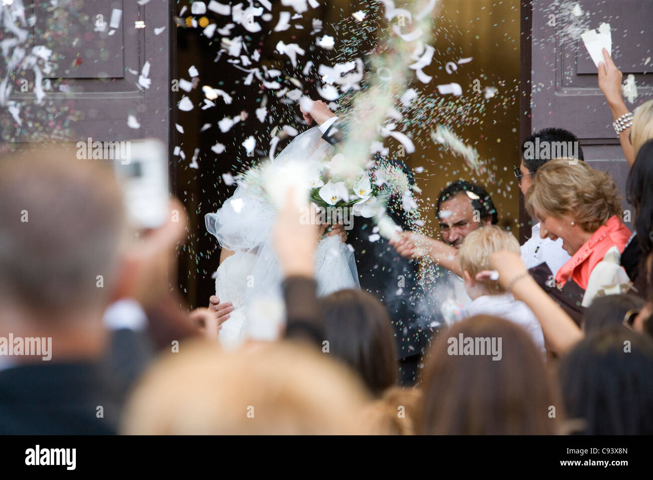 Couple covered in confetti and rice at their wedding in Bari Puglia ...