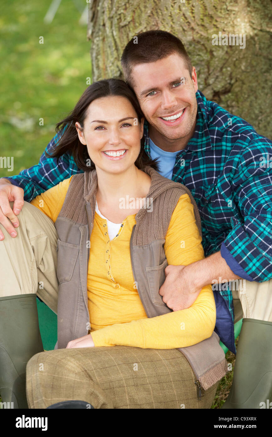 Man sitting against tree trunk hi-res stock photography and images - Alamy