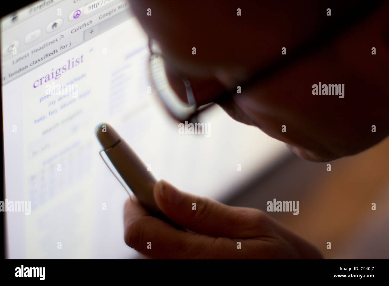 Close-up of a man browsing the craigslist website on a computer ...