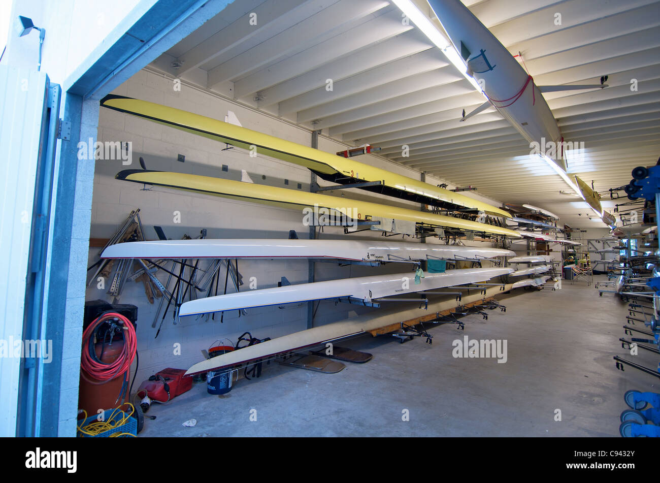 A boat house with scull rowboats inside Stock Photo - Alamy