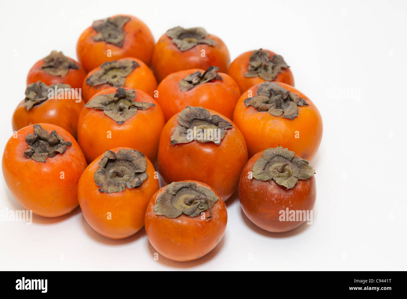 Red juicy persimmons isolated on white background Stock Photo - Alamy