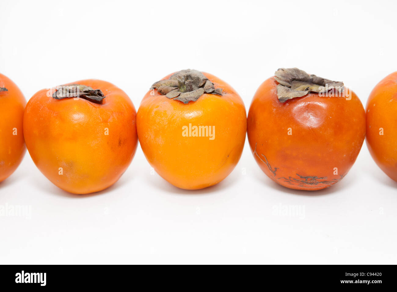 Red juicy persimmons isolated on white background Stock Photo - Alamy