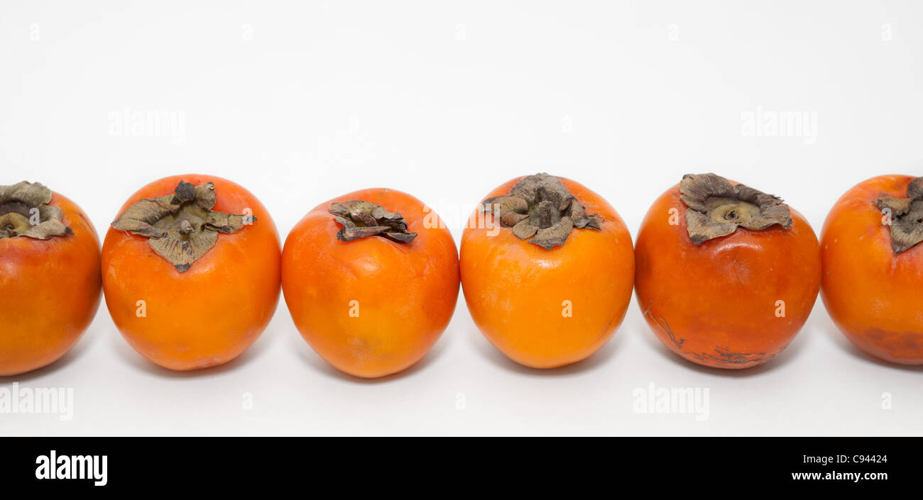 Red juicy persimmons isolated on white background Stock Photo - Alamy