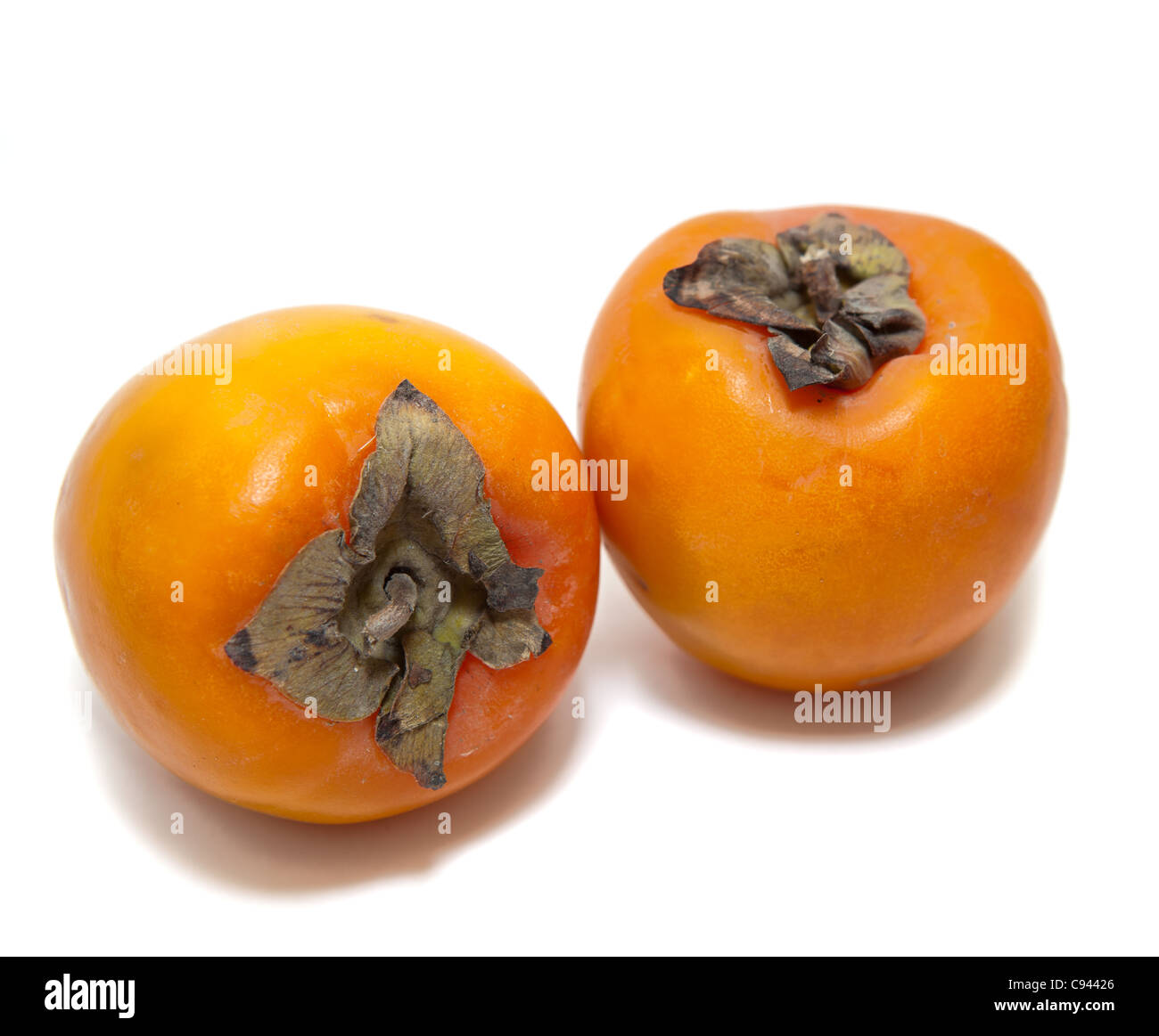 Red juicy persimmons isolated on white background Stock Photo - Alamy