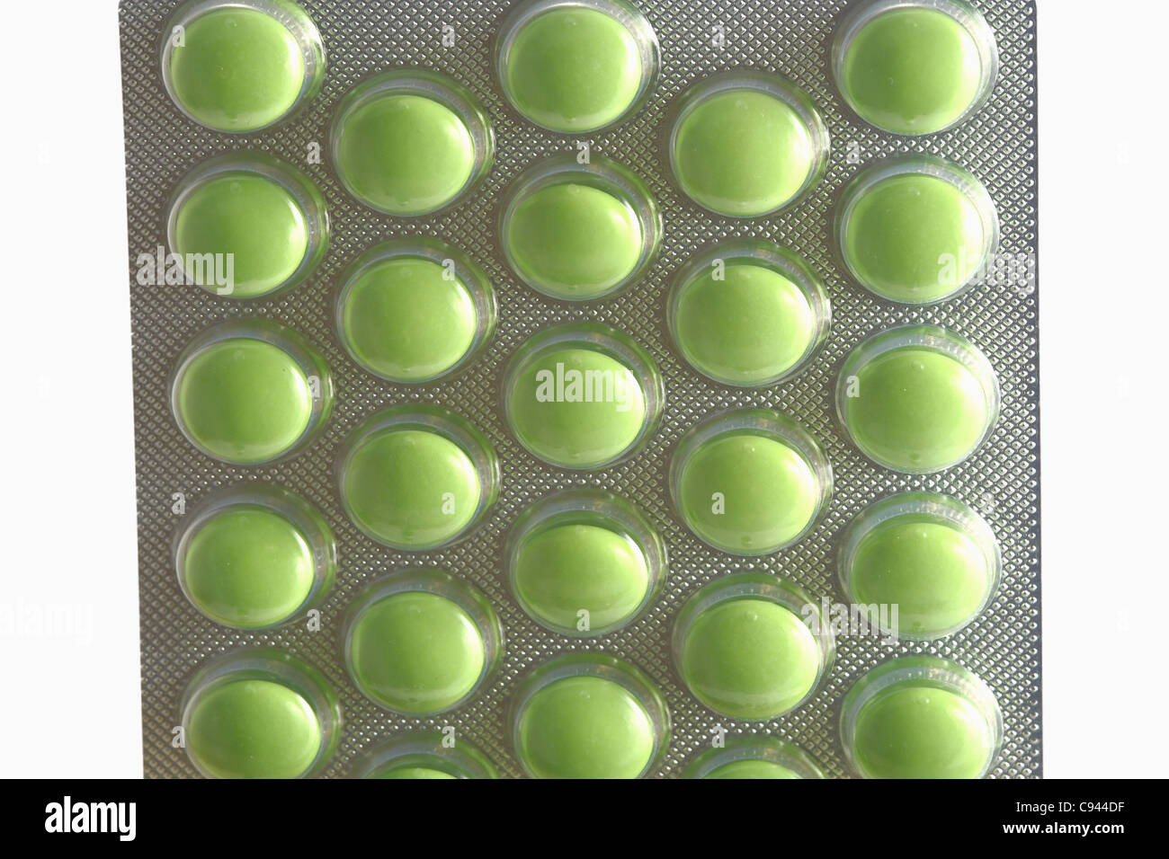 green pills tablets isolated on white background Stock Photo - Alamy