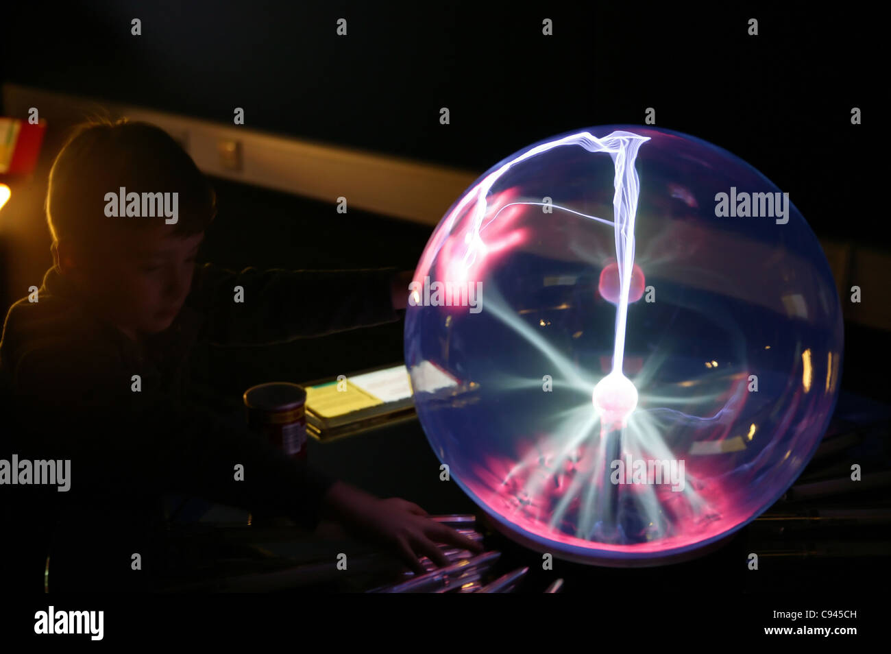 Boy playing with Plasma Ball Stock Photo - Alamy