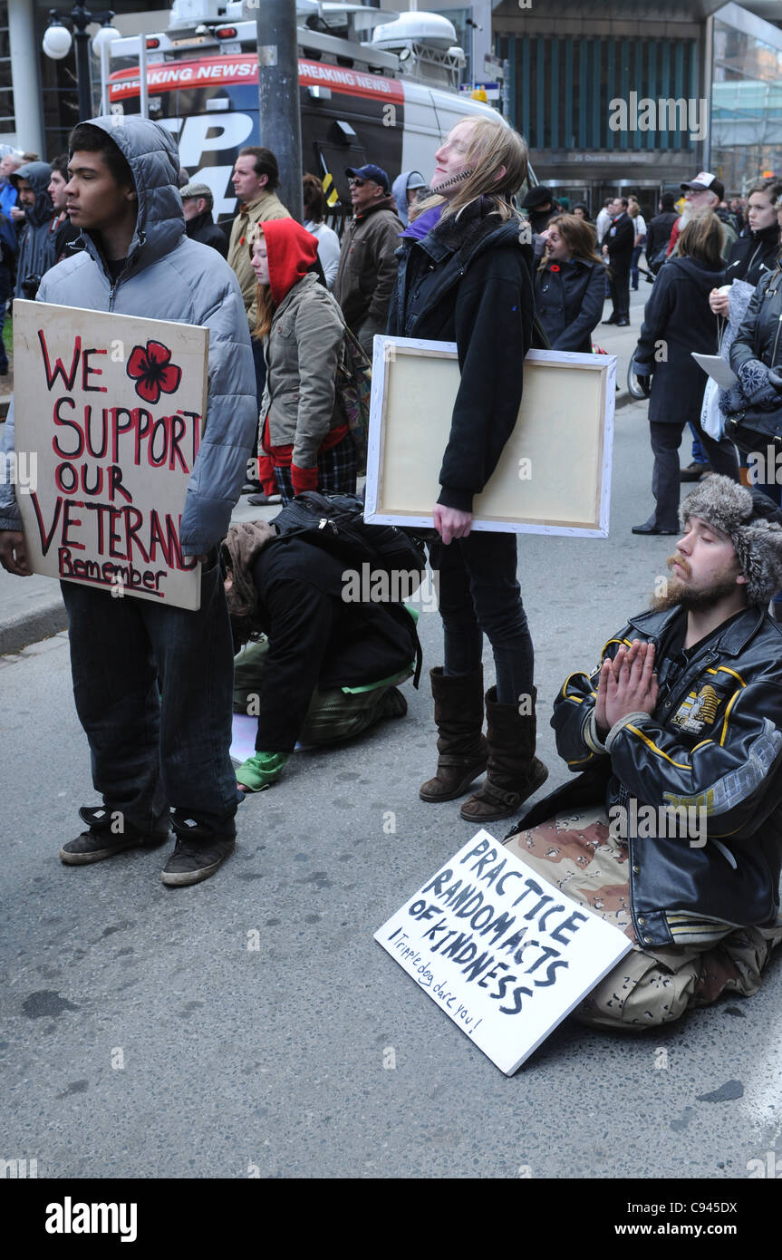 A group of five unidentified Occupy Toronto protesters joins the crowd ...