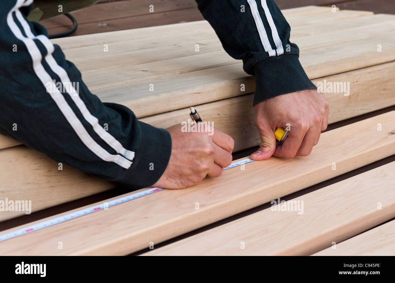 A carpenter measuring Stock Photo - Alamy