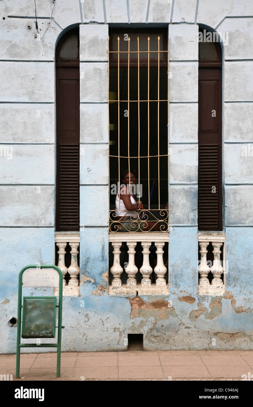 Young Cuban woman behind the traditional barred window in Trinidad ...