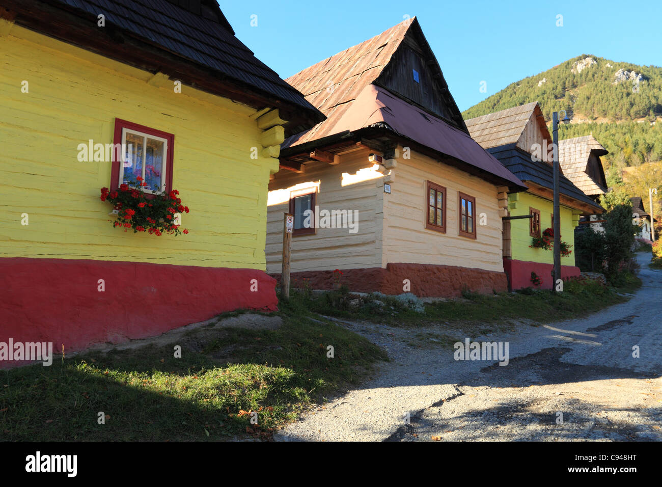 Traditional painted wooden cottages in Vlkolinec, Slovakia. Village is ...