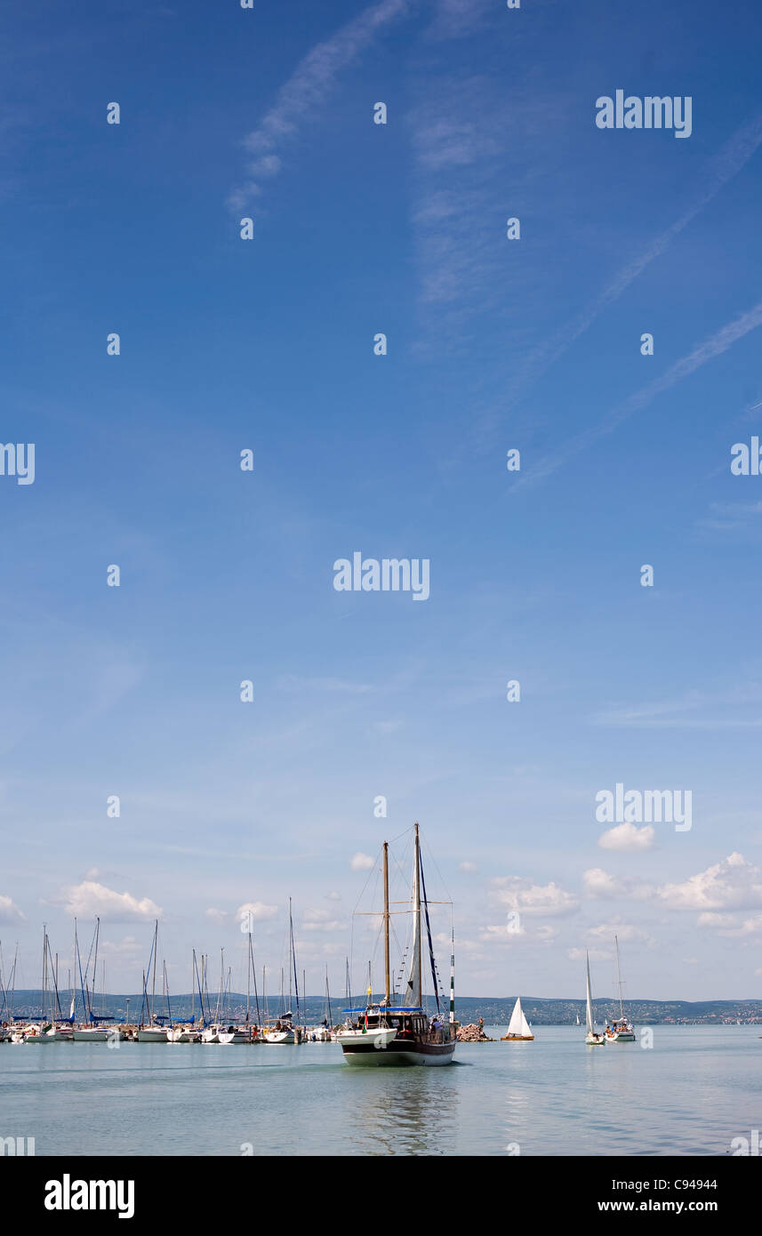 Boat sailing away from the port Stock Photo - Alamy