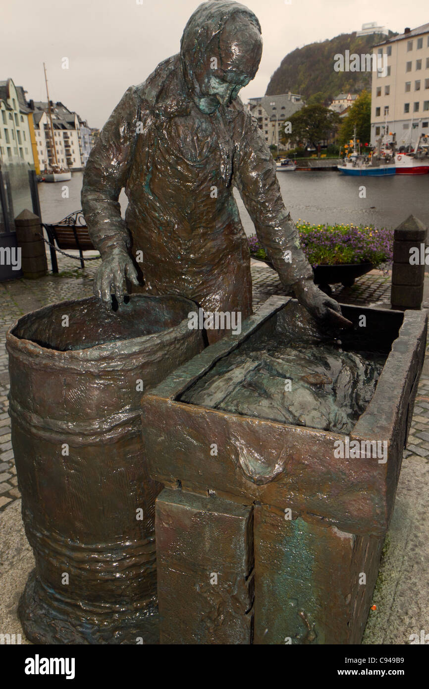 Statue of a fisherwomen sorting through a days catch of fish Stock ...