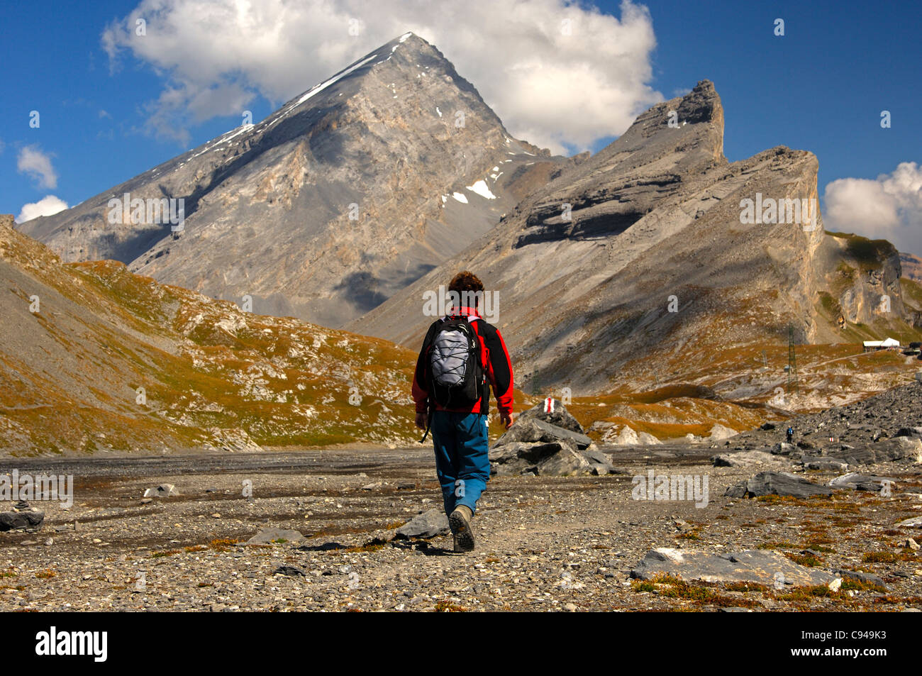 Hiker on the Laemmerboden plateau on the way to the Gemmi Pass ...