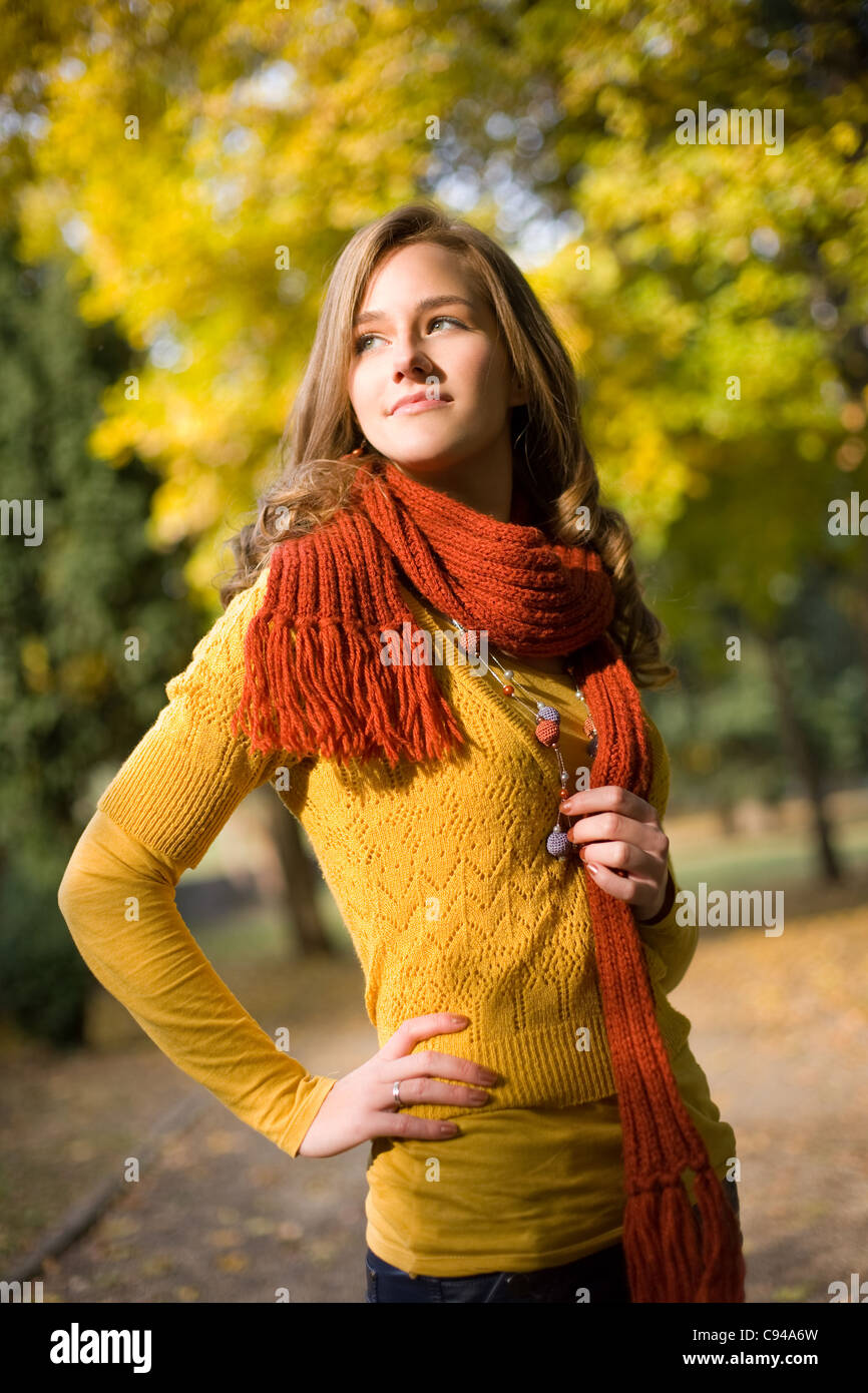Half length portrait of dreamy fall fashion girl in colorful clothes ...