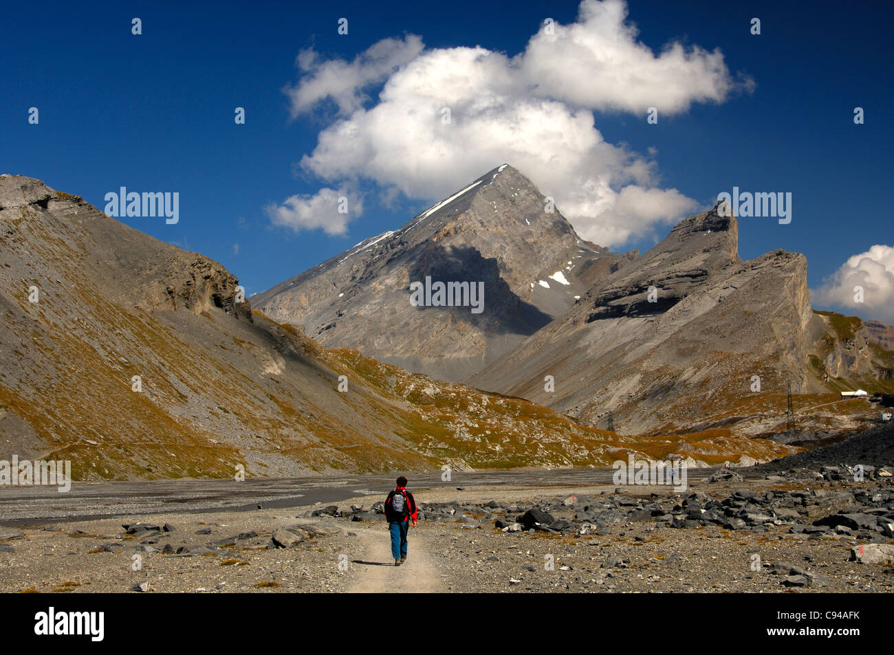 Hiker on the Laemmerboden plateau on the way to the Gemmi Pass ...
