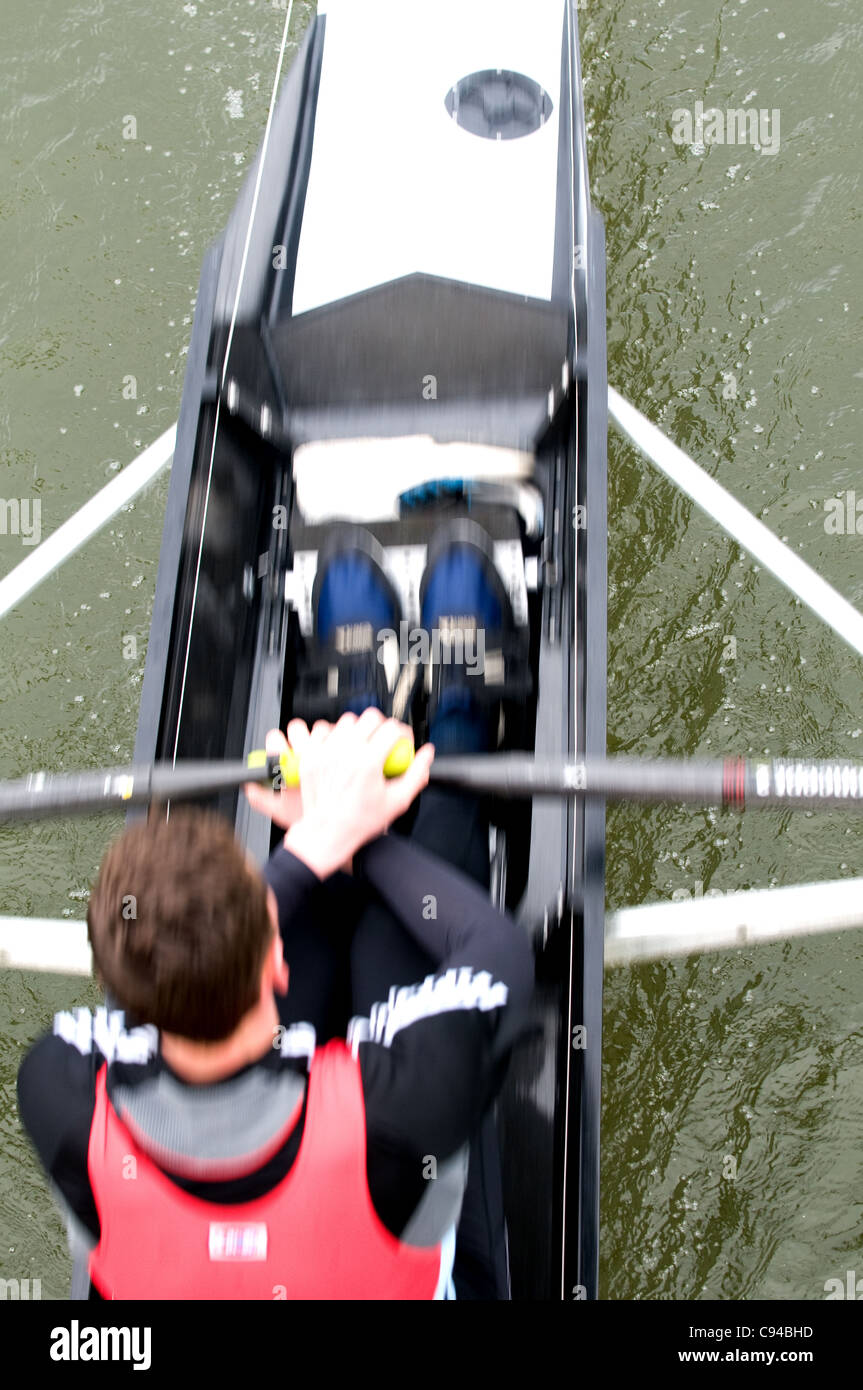 Single scull passing under a bridge at Bedford Spring Regatta. Scull is ...