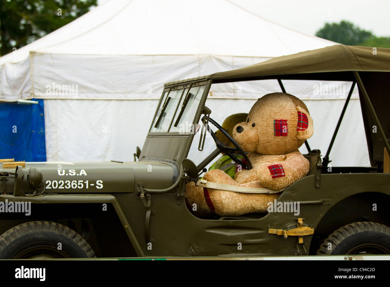 2 stuffed teddy bears in a jeep 4 x 4. 1 in the driving seat other in ...