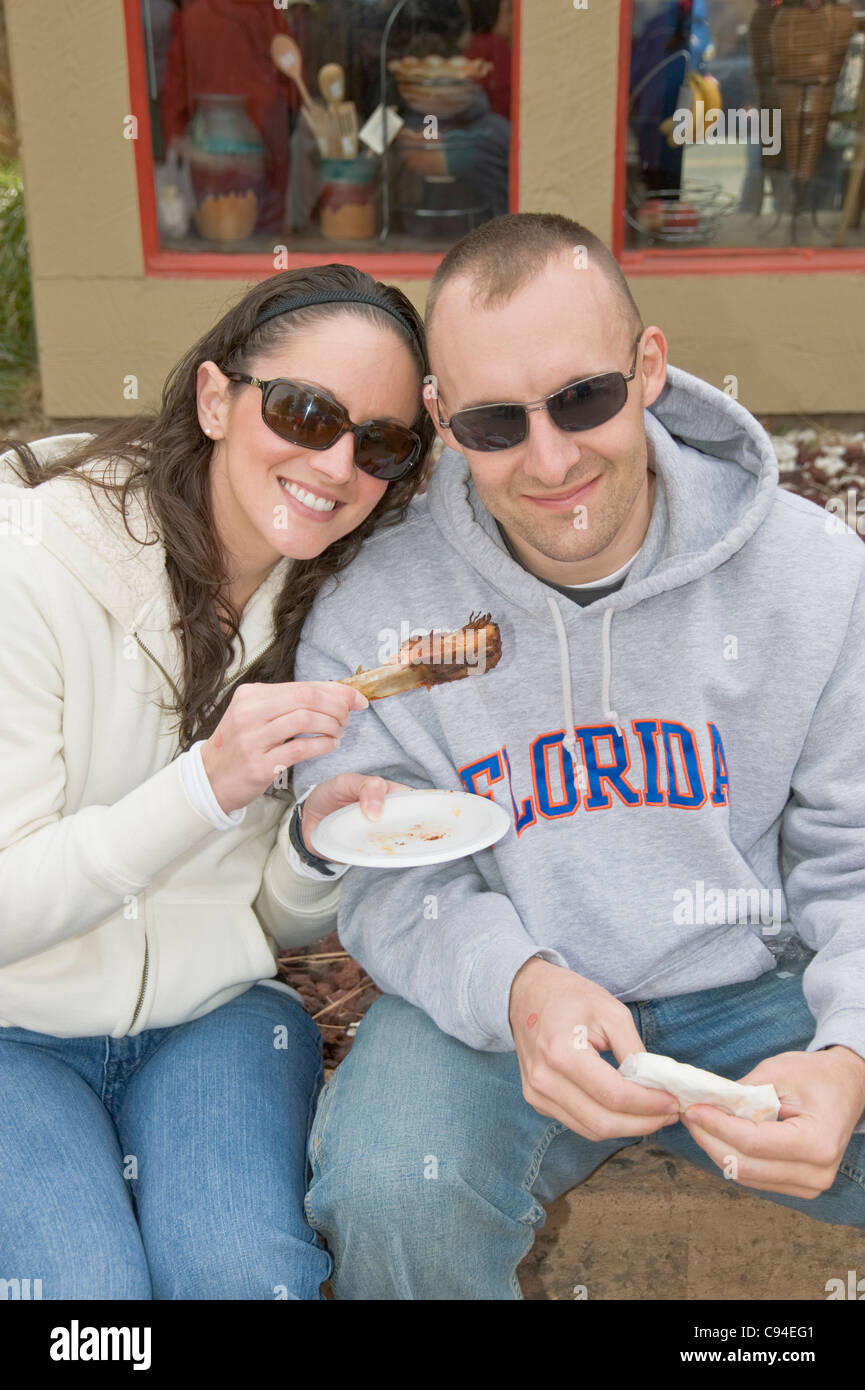 A happy couple enjoys barbecued ribs at the Ruidoso R & R Block Party ...