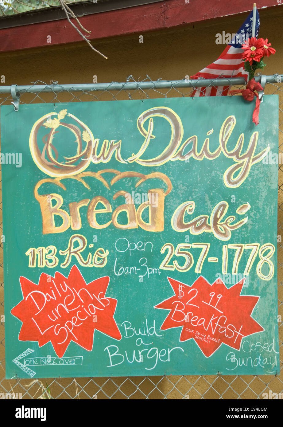 A colorful sign directing visitors to the Our Daily Bread cafe in ...