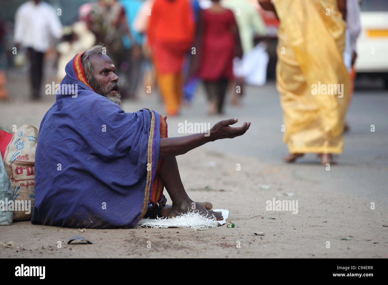 Beggar and Pilgrims walking around the mountain of Arunachala during ...