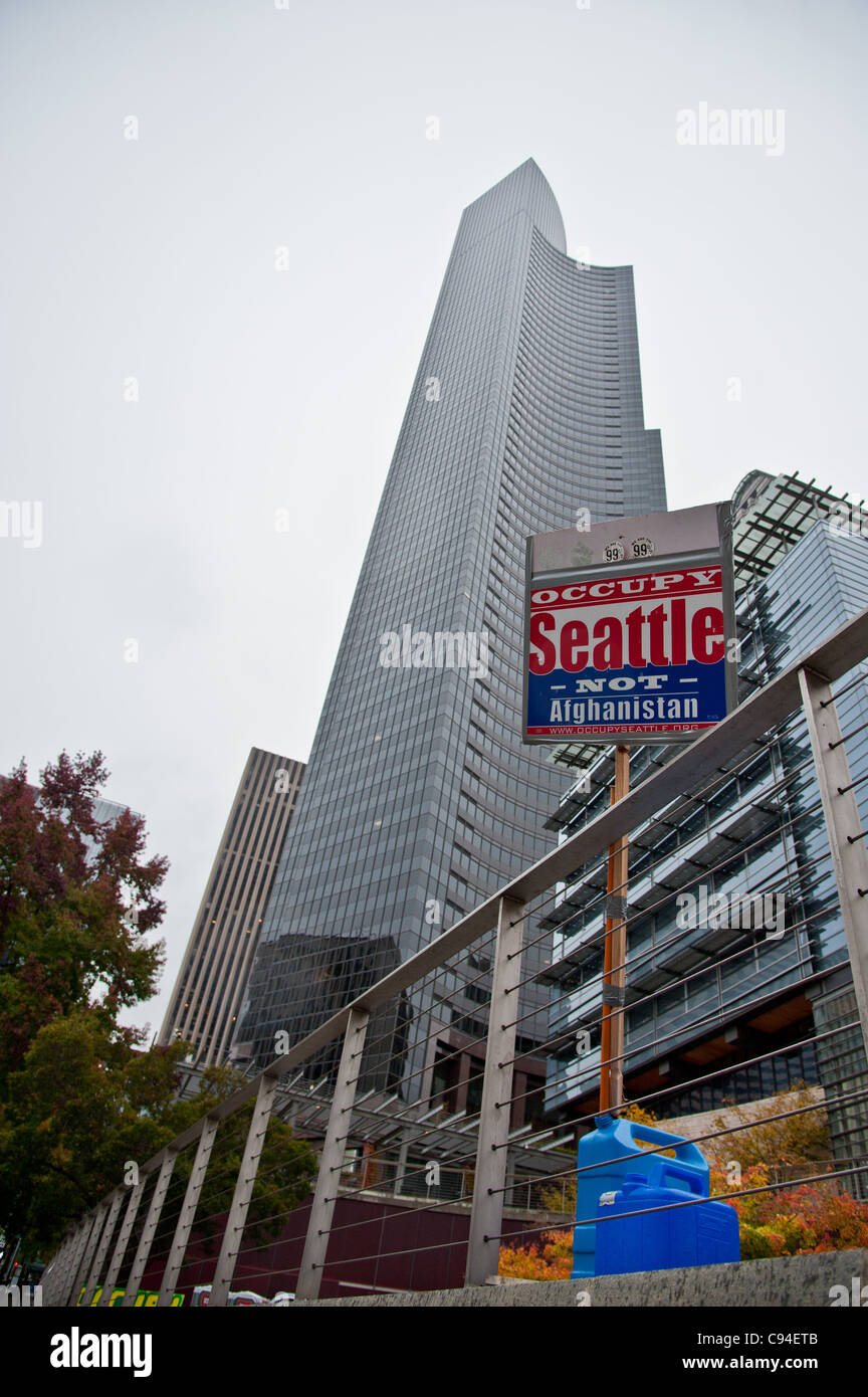 A "Occupy Seattle" sign with downtown skyscraper in the background ...