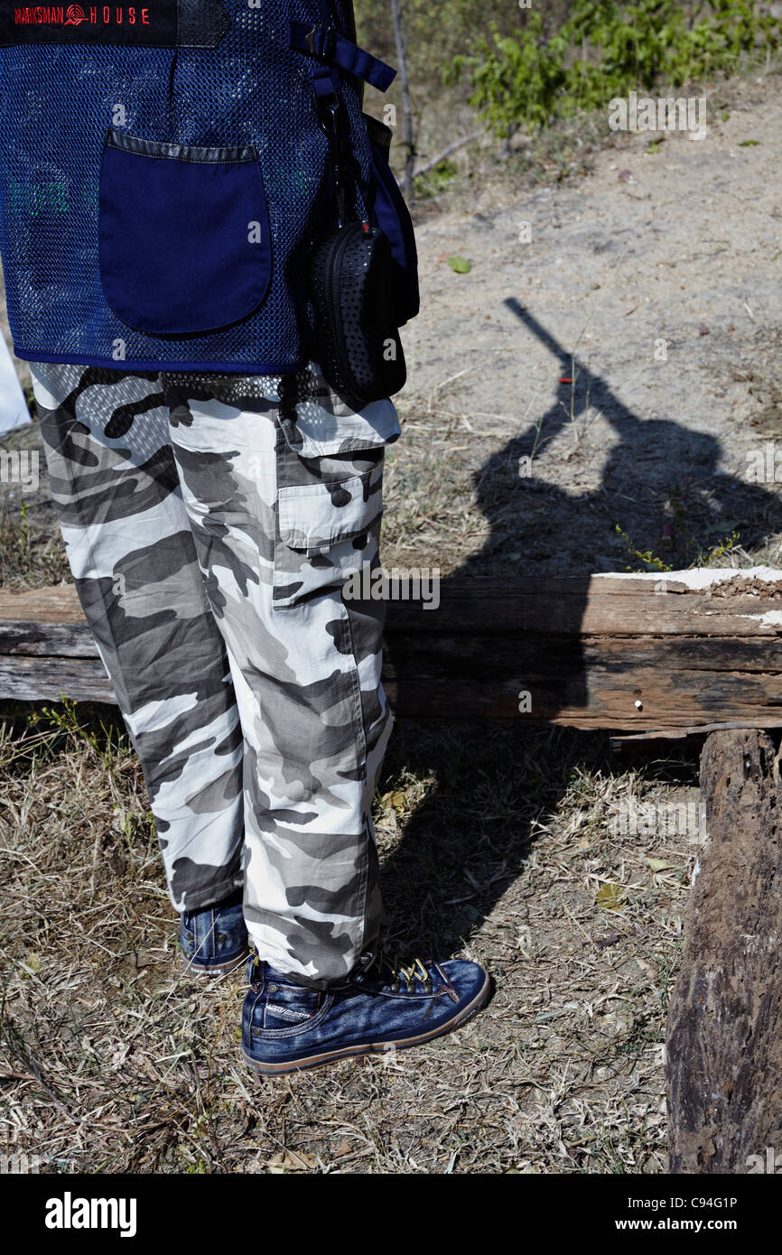 Rear view and shadow of a man shooting a rifle Stock Photo - Alamy