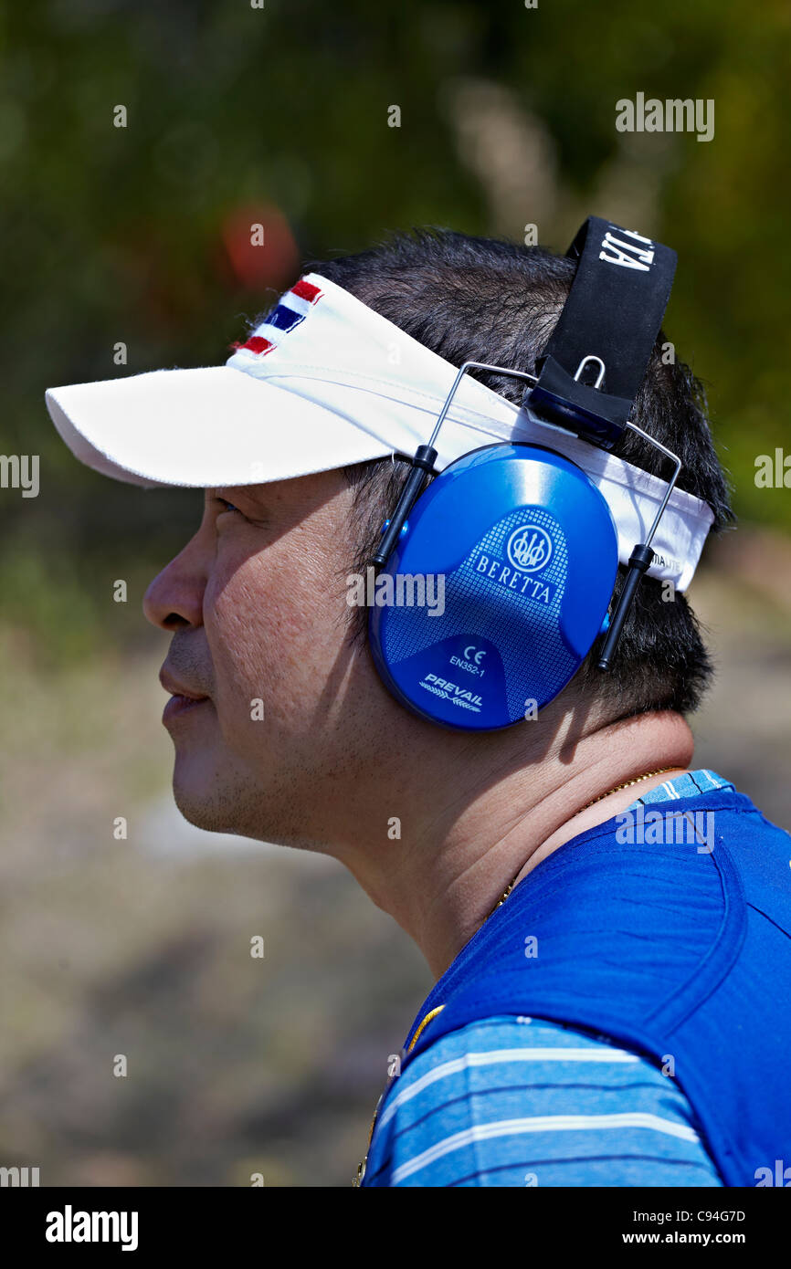 Ear protectors worn by man at a clay pigeon shoot Stock Photo - Alamy