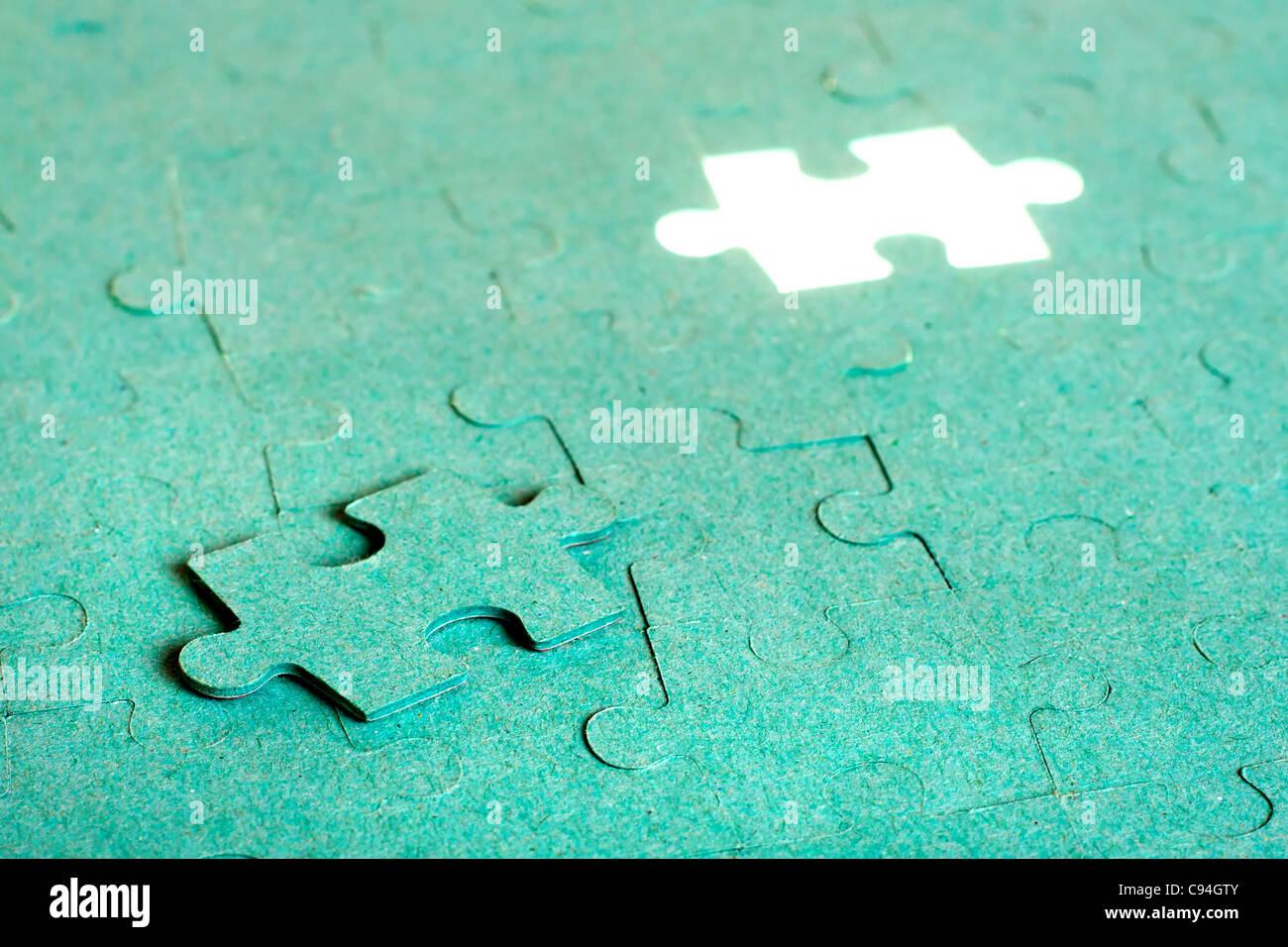 Green puzzle with missing piece Stock Photo - Alamy