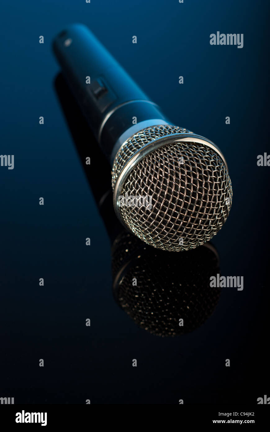 Microphone with reflection on black background with blue lights Stock ...