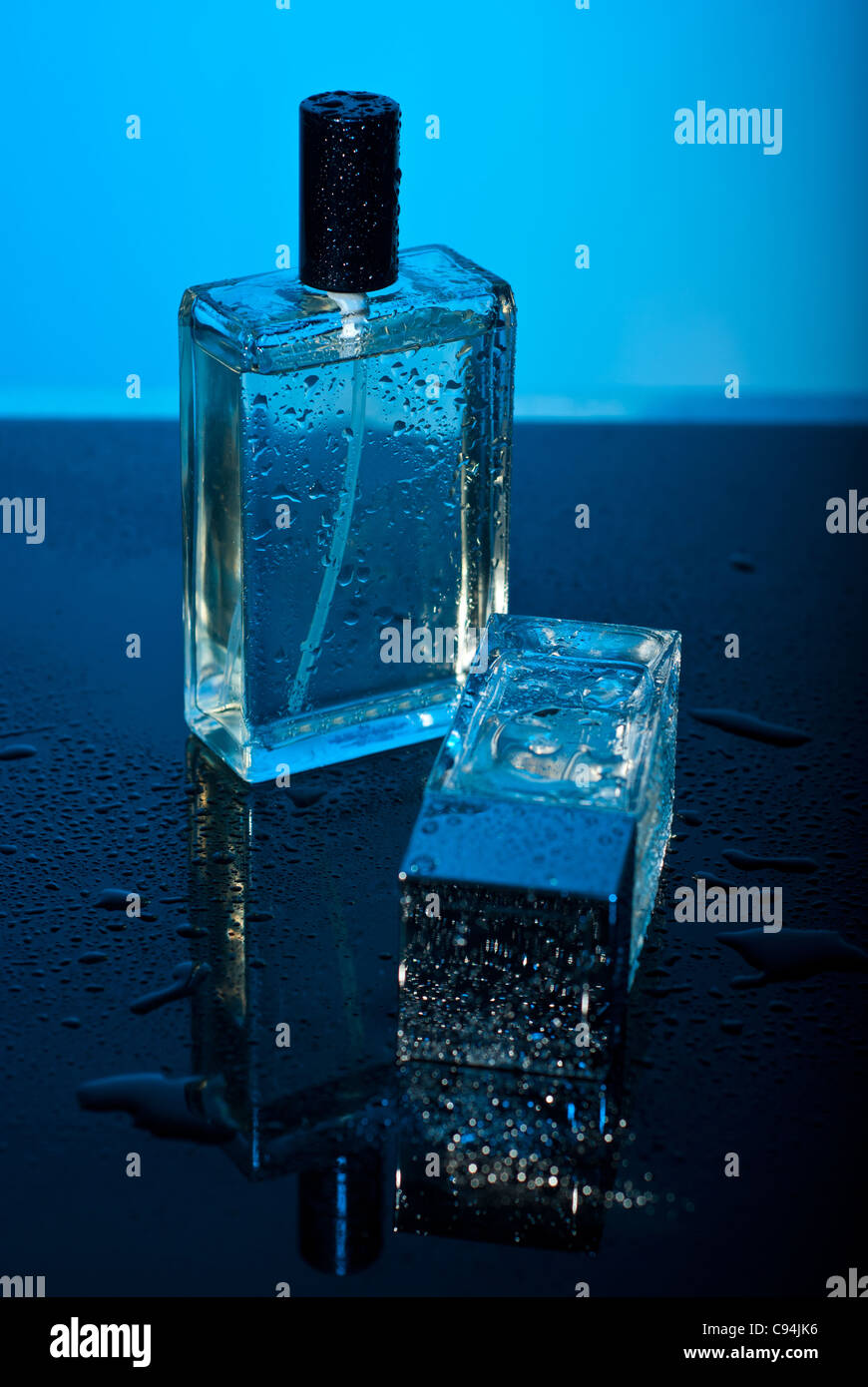 Two bottles perfume with water drops and blue lights Stock Photo - Alamy