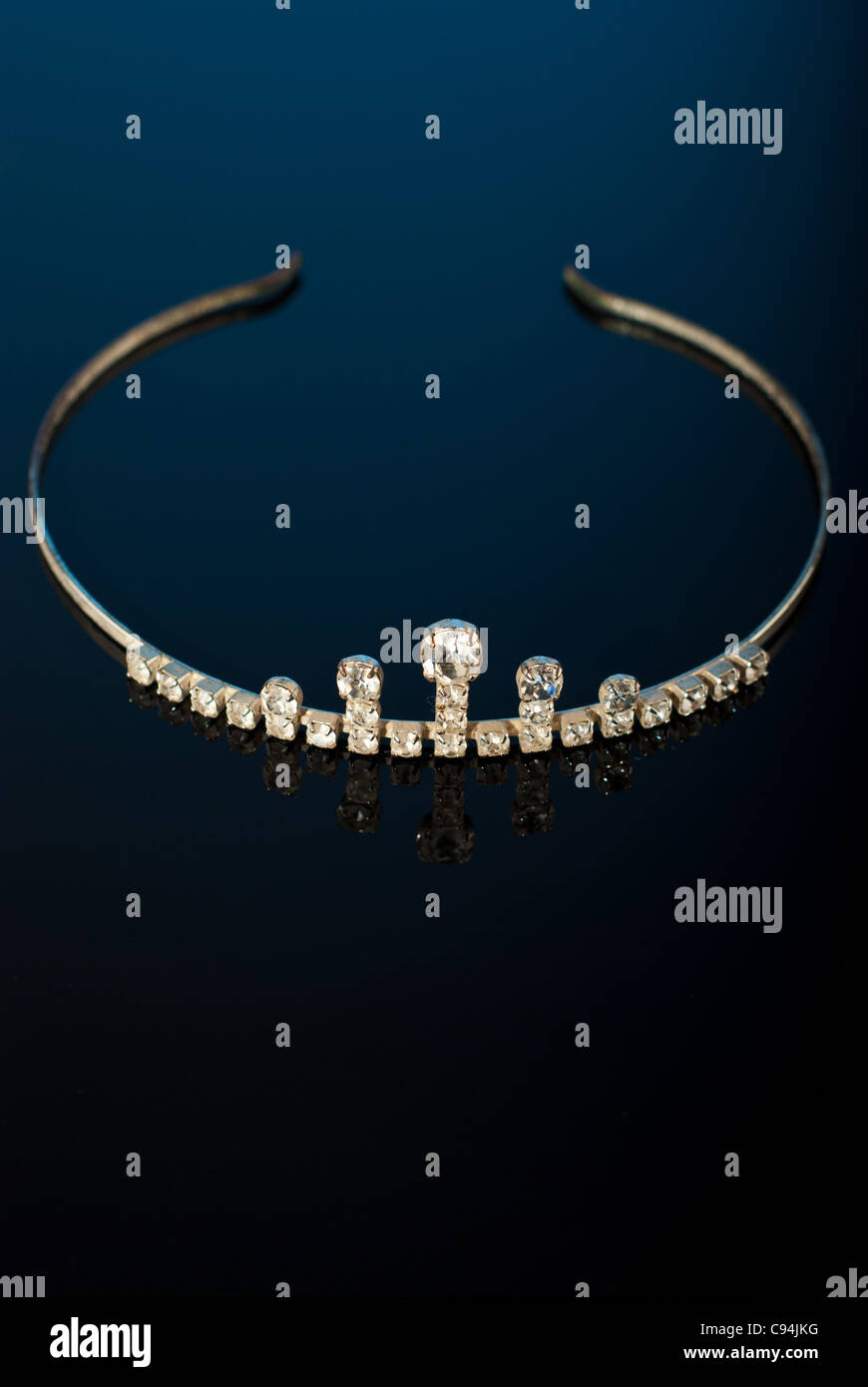 Tiara on black background with reflection and blue lights Stock Photo ...